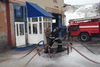 Fireman uses fire hoses to make a hovercraft. : r/gifs